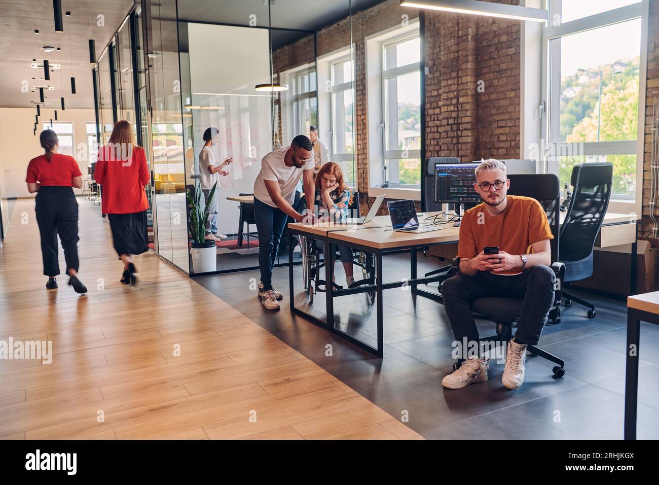 A diverse group of business professionals collaborates in a modern ...