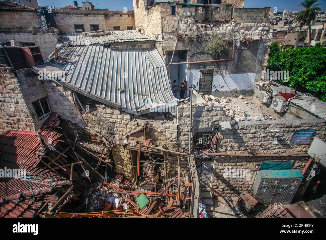 Jenin, Palestine. 17th Aug, 2023. Palestinians inspect the effects of ...