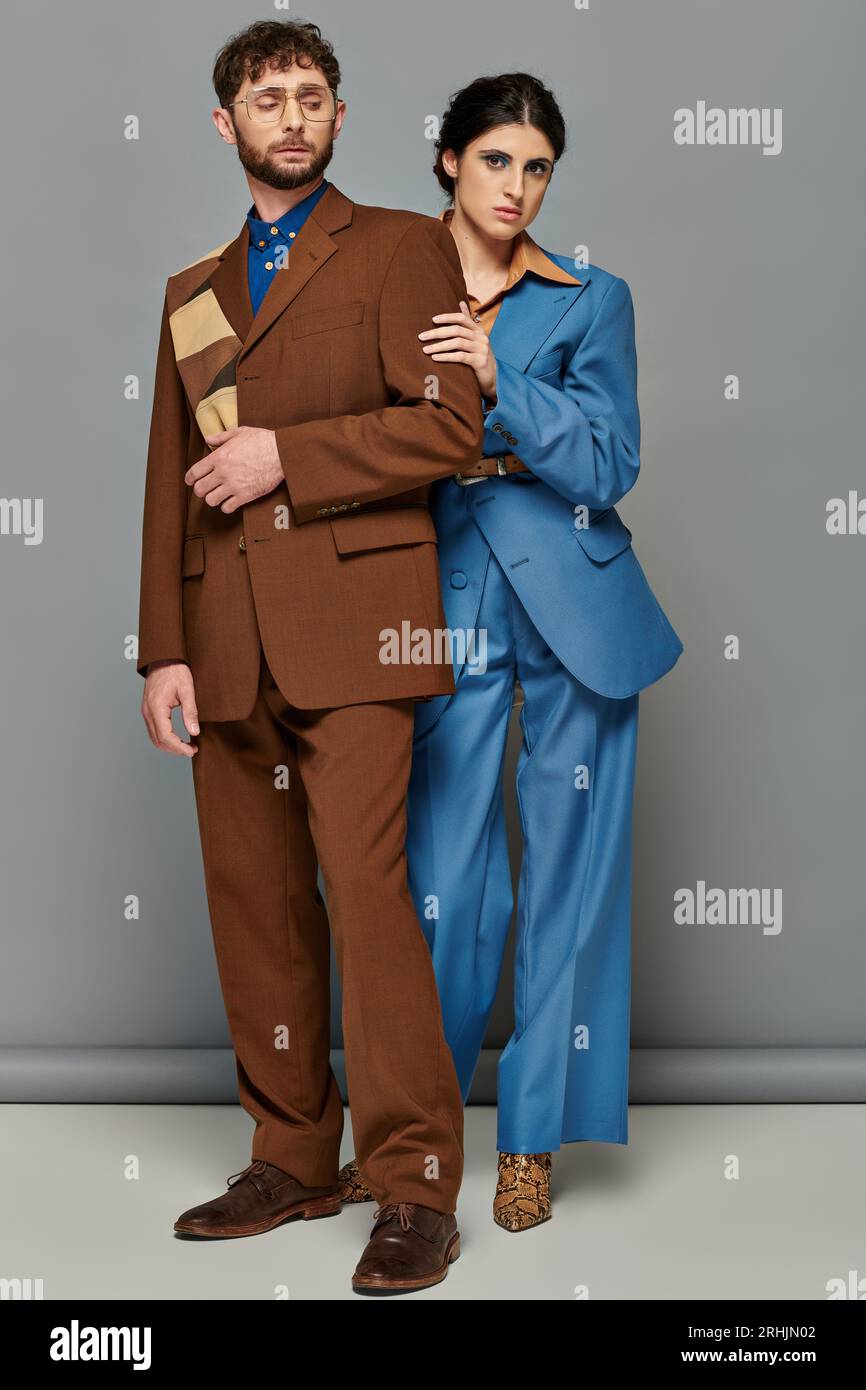 sophisticated style, couple in tailored suits, formal attire, grey ...