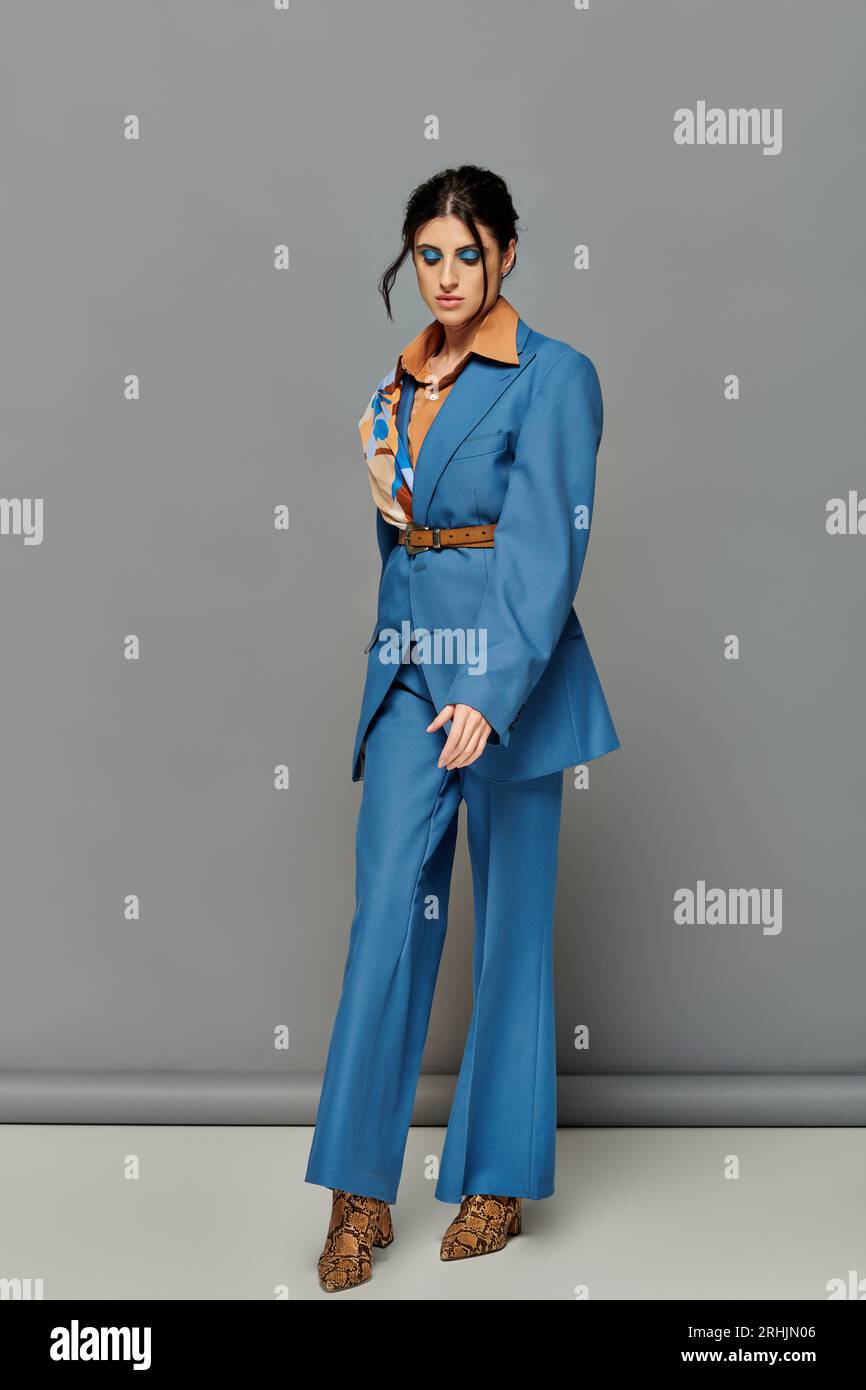 pretty woman with bold makeup, model in blue tailored suit, formal ...