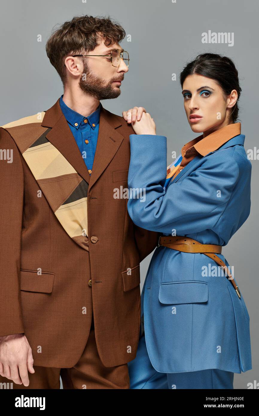 fashionable couple, models posing in formal attire, looking at camera ...