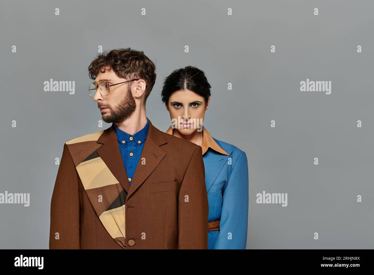 fashion shoot, couple in trendy suits, tailored, stylish formal attire ...