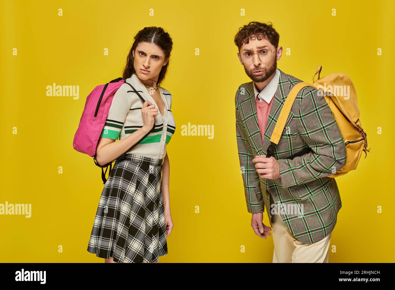 curious students standing with backpacks, looking at camera, yellow ...