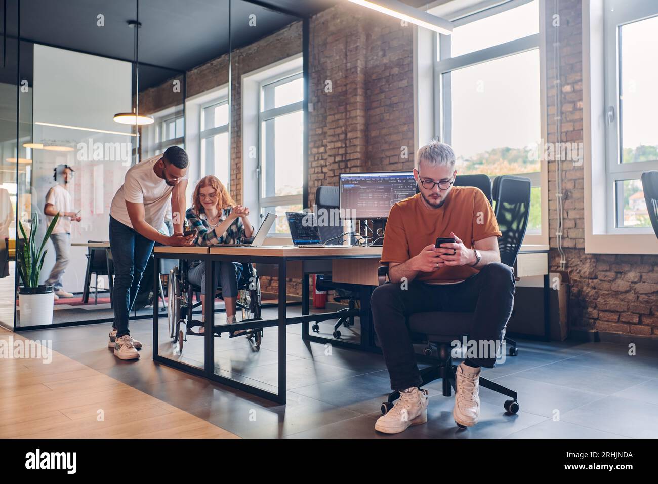 A diverse group of business professionals collaborates in a modern ...