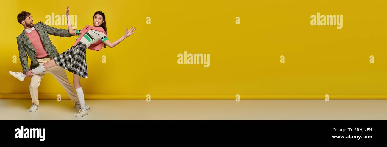 cheerful man in glasses catching falling woman, young couple, funny ...