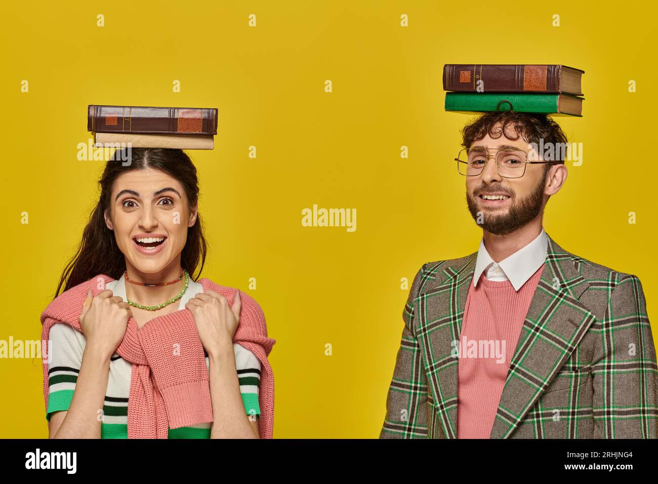 couple of students, happy man and excited woman standing with books on ...
