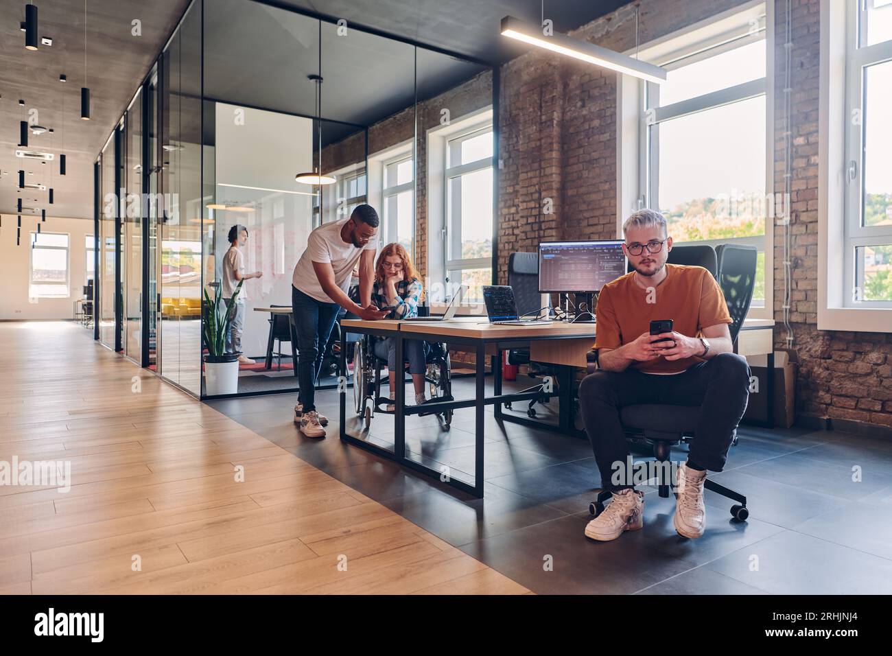 A diverse group of business professionals collaborates in a modern ...