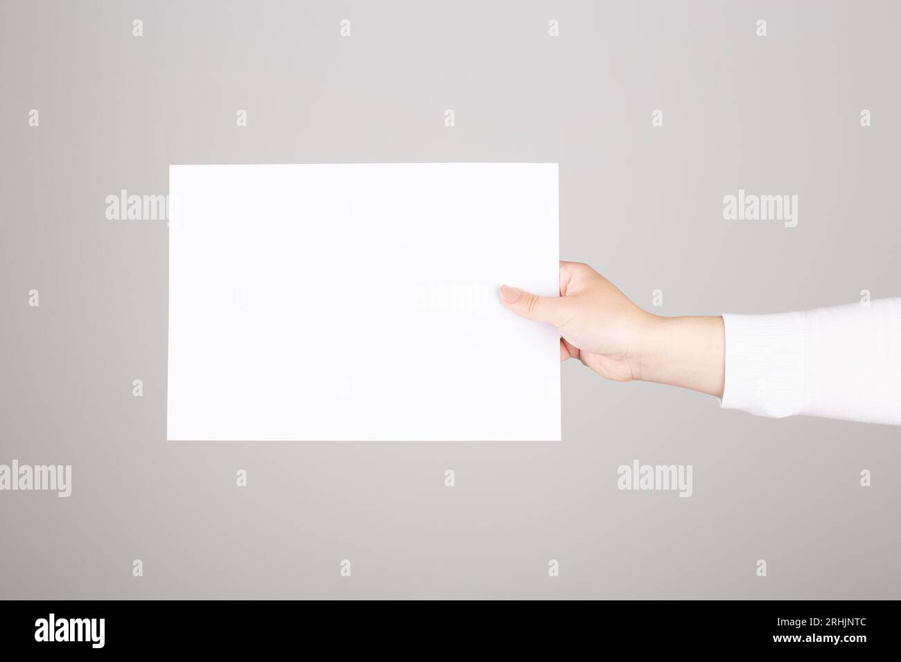 Hand holds sheet white hi-res stock photography and images - Alamy