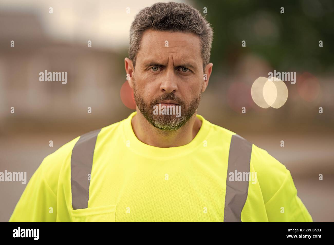 Grizzled man portrait. Worker man. Serious man wearing yellow safety ...