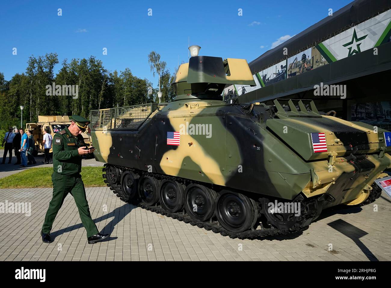 Russian officer walks past a damaged American M113 armored personnel ...
