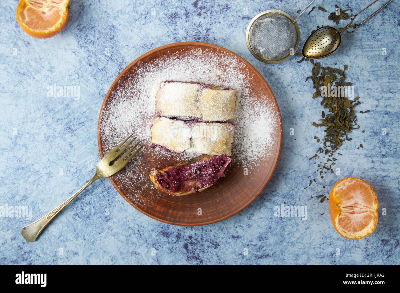 Strudel pastry food photography on blue background and brown plate ...