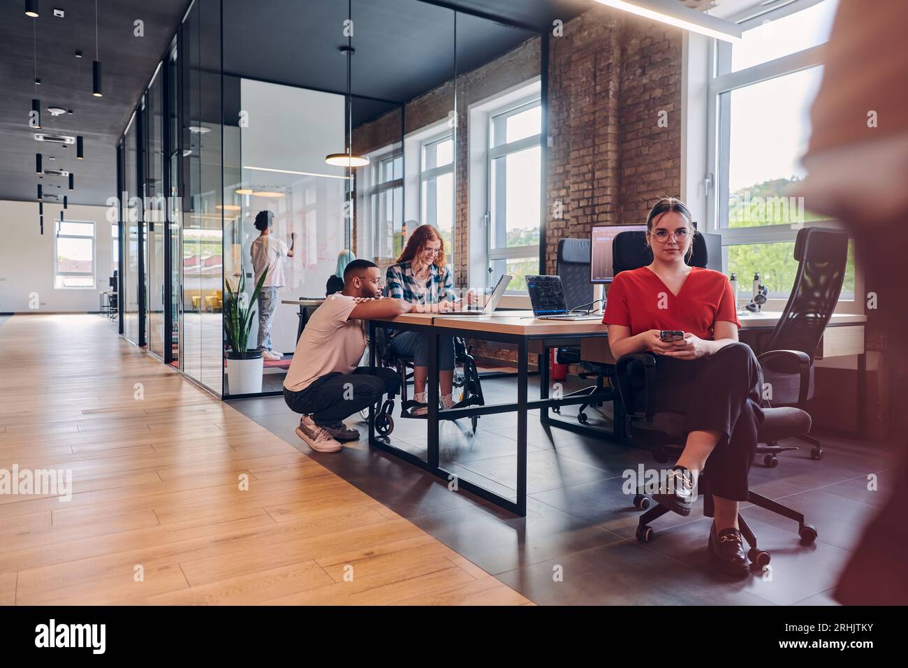 A diverse group of business professionals collaborates in a modern ...