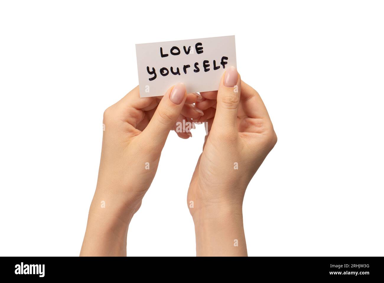 Love yourself text on a card in a woman hand isolated on a white ...