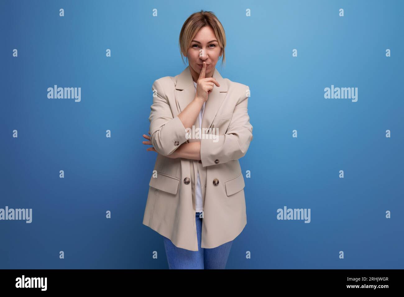pensive serious blond business young woman in jacket on studio ...