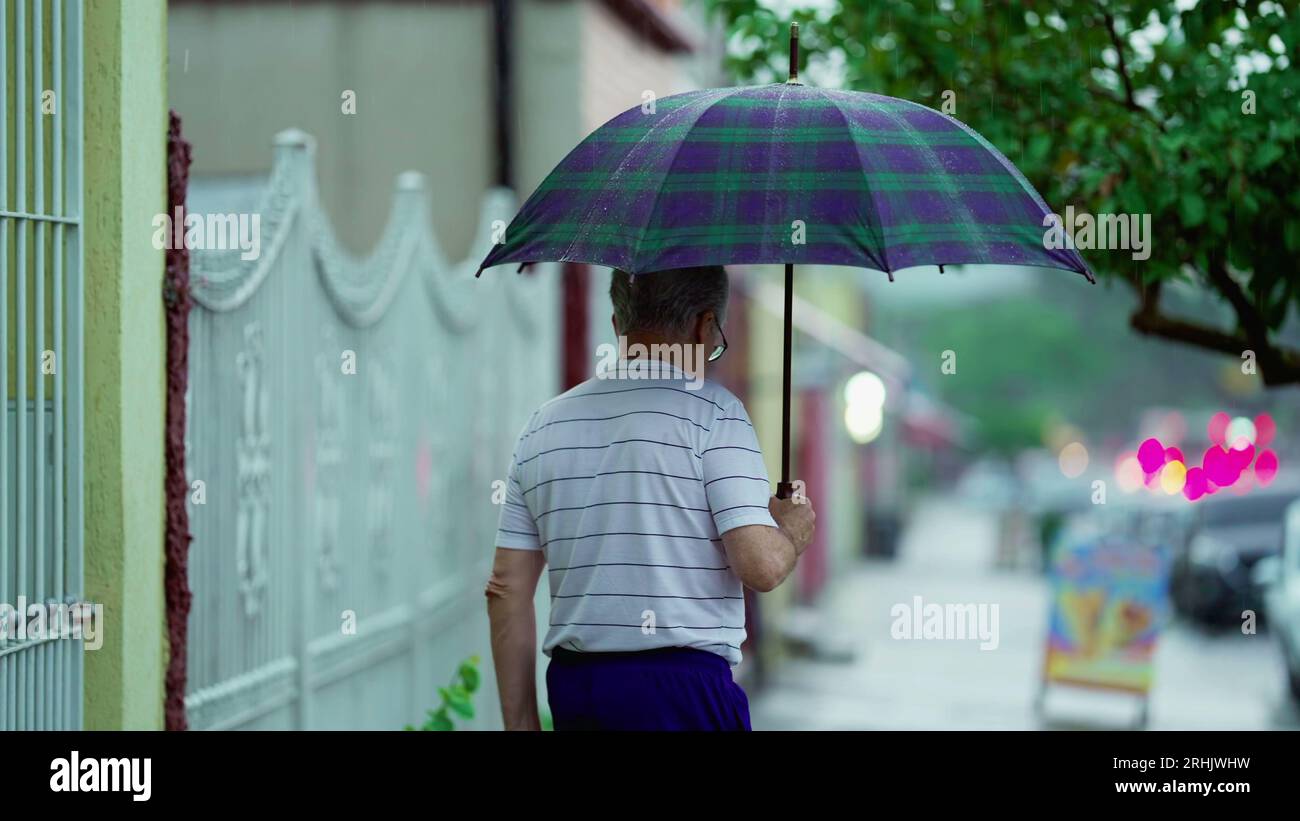 Older Man Steps Out in Rain, Opens Umbrella and Shuts Gate, Walks on ...