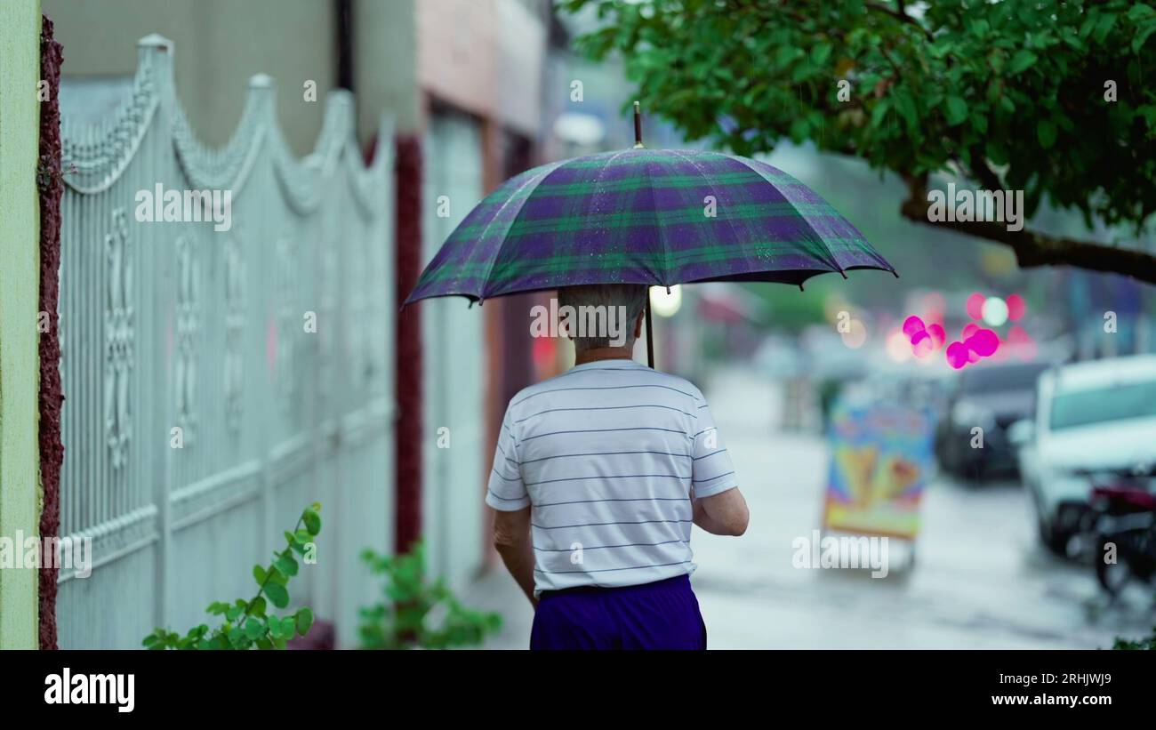 Older Man Steps Out in Rain, Opens Umbrella and Shuts Gate, Walks on ...