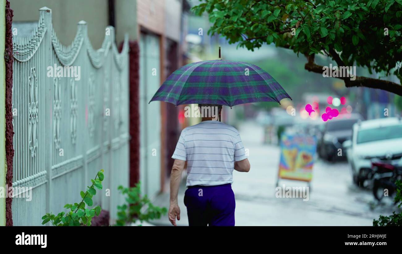 Older Man Steps Out in Rain, Opens Umbrella and Shuts Gate, Walks on ...