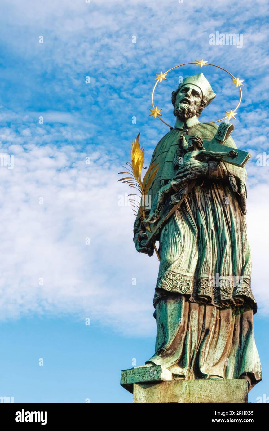 Statue of John of Nepomuk on Charles Bridge in Prague against the sky ...