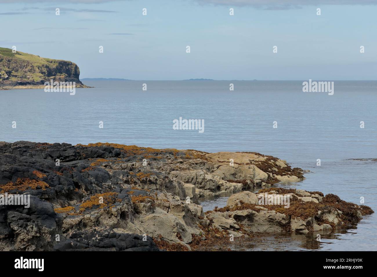 View over the rocky beach at Ardmore Bay to the sea beyond Stock Photo ...