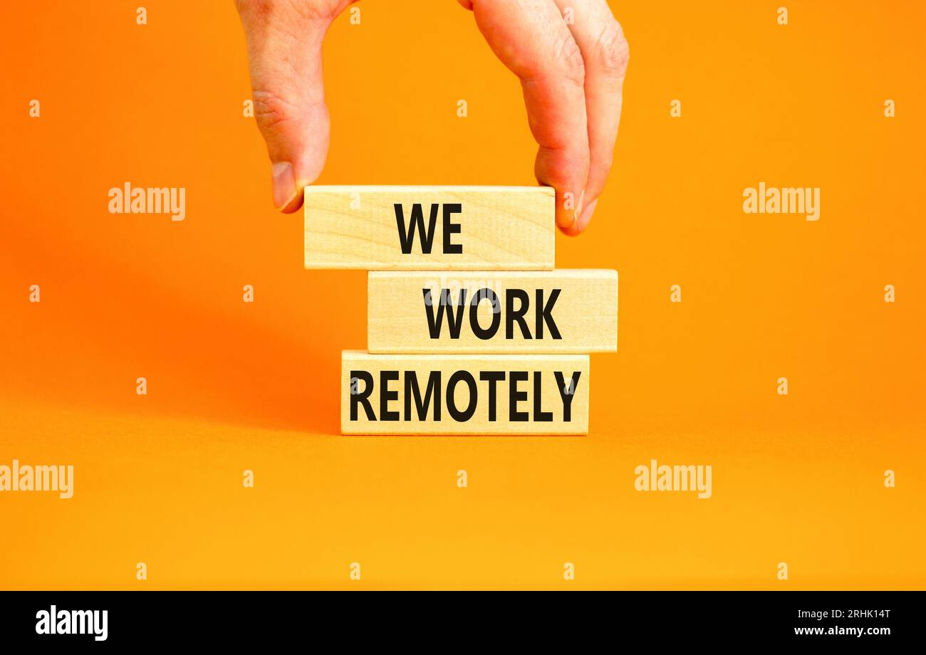 We work remotely symbol. Concept words We work remotely on wooden block ...