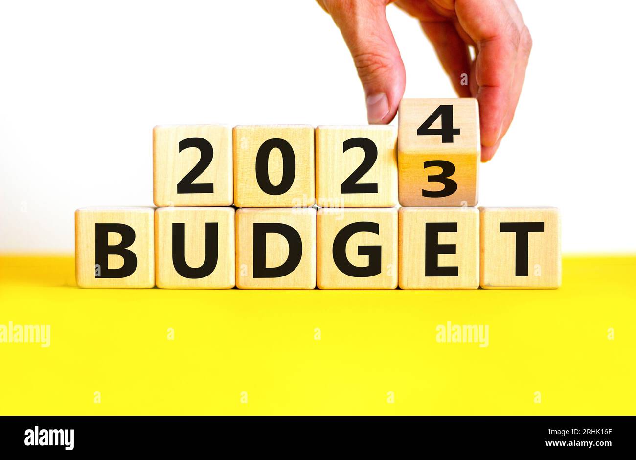 Planning 2024 budget new year symbol. Businessman turns a wooden cube ...