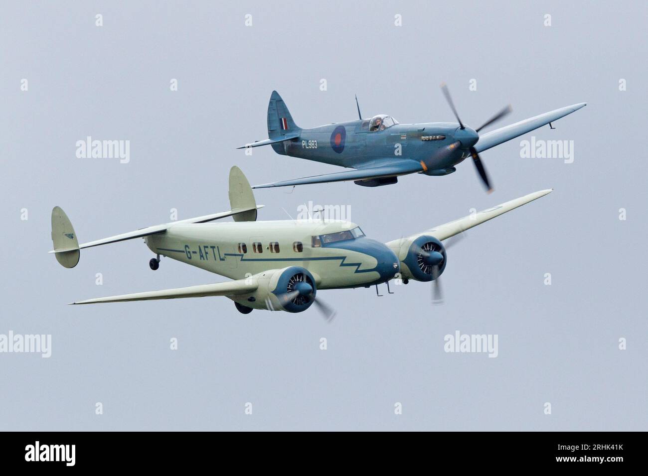 Spitfire and Lockheed Electra flying in formation at RAF Duxford during ...
