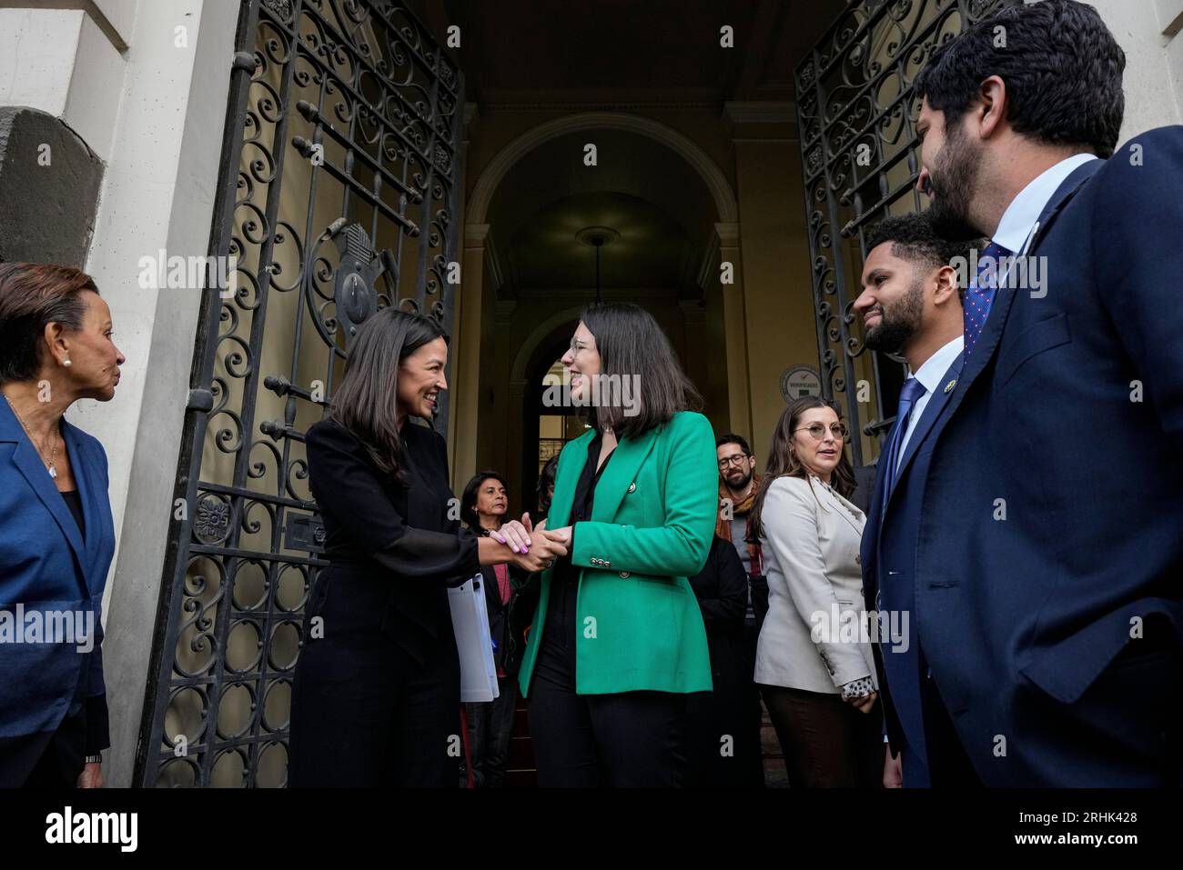 Congresswoman Alexandria Ocasio-Cortez, (D-NY), center left, shakes ...