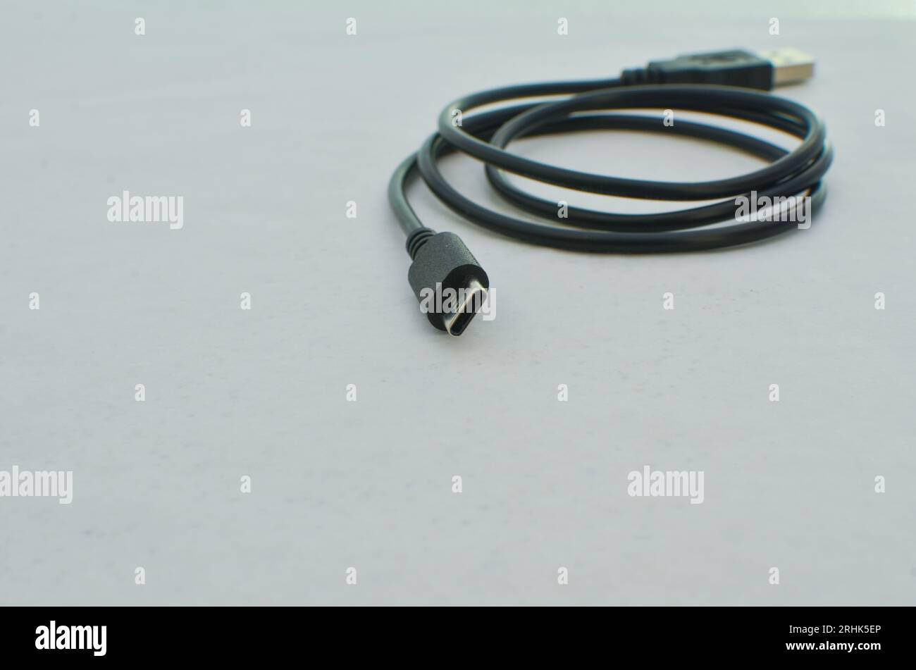 Black USB Type-C cable detail highlighted on a clear surface, perfect ...