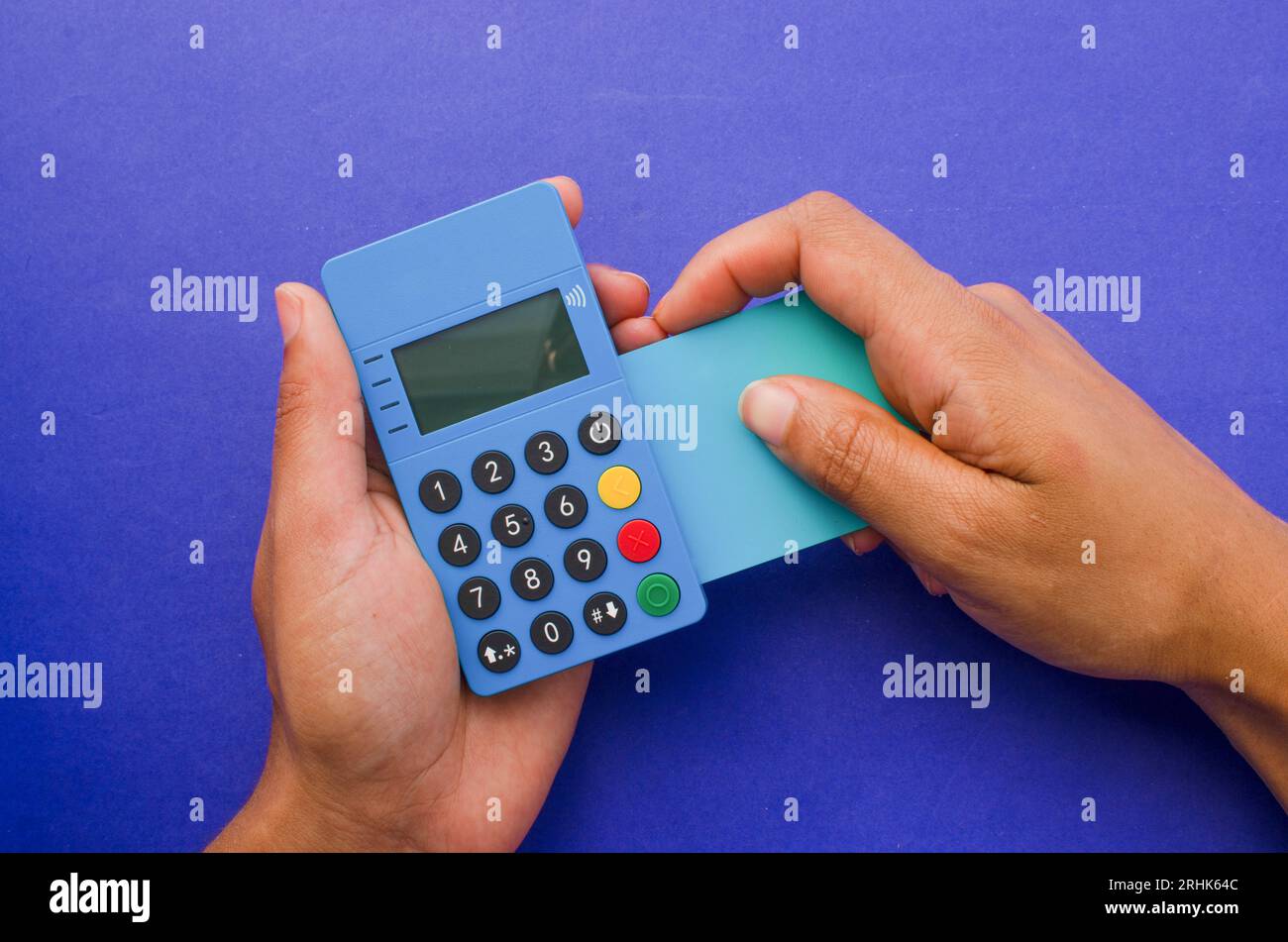 Hands holding a portable contactless payment device, An ultra-light and ...