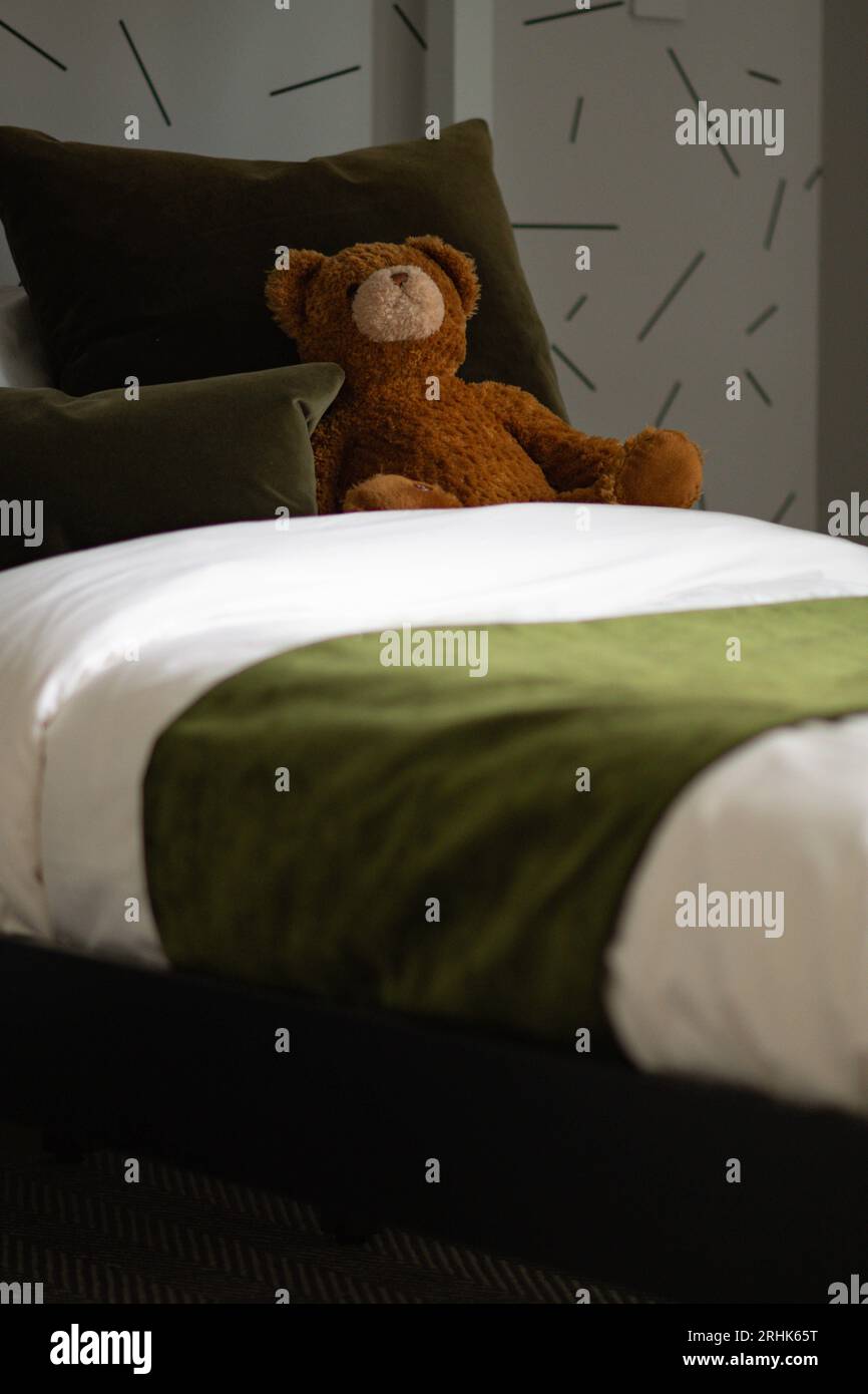 Stuffed bear on set bed kids bedroom copy space image Stock Photo - Alamy