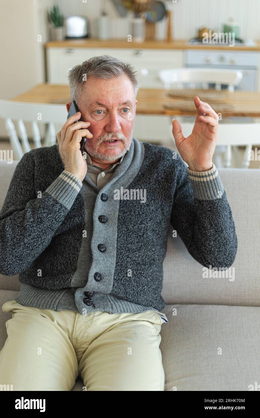 Happy middle aged senior man talking on smartphone with family friends ...