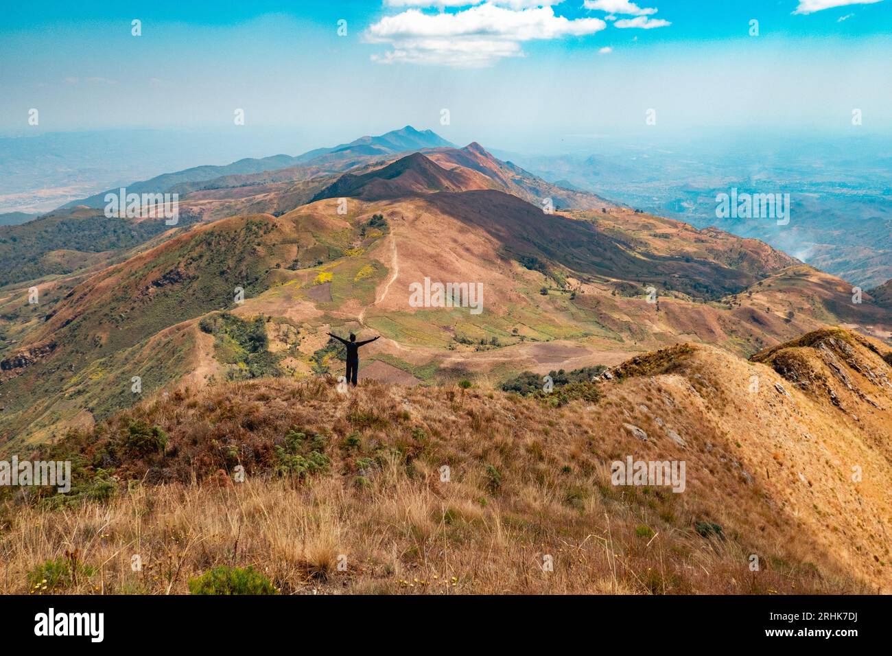 Scenic hiew of a hiker against a mountain background at Mbeya Range in ...