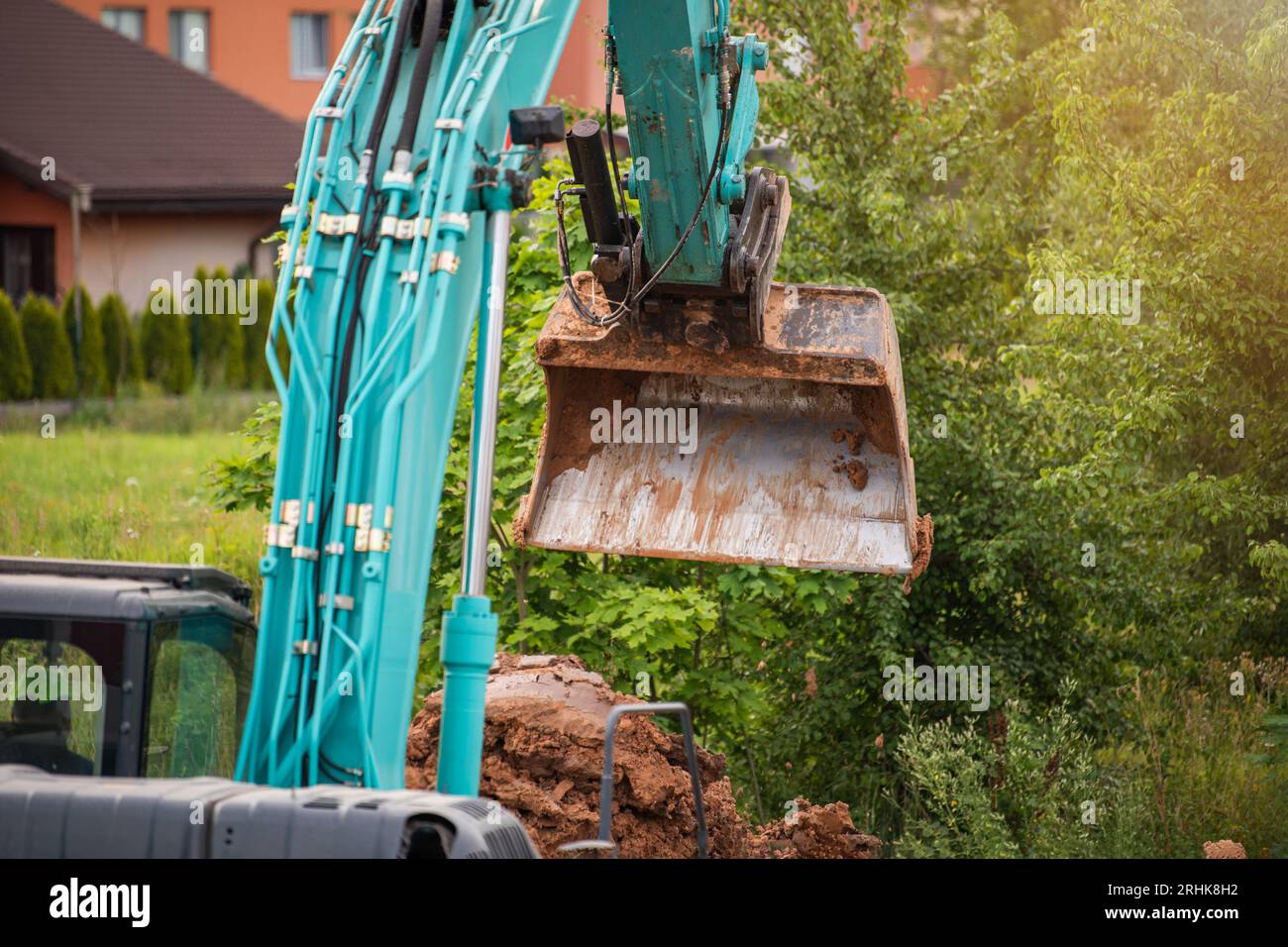 Road repair. The excavator pours the accumulated dirt into a place ...