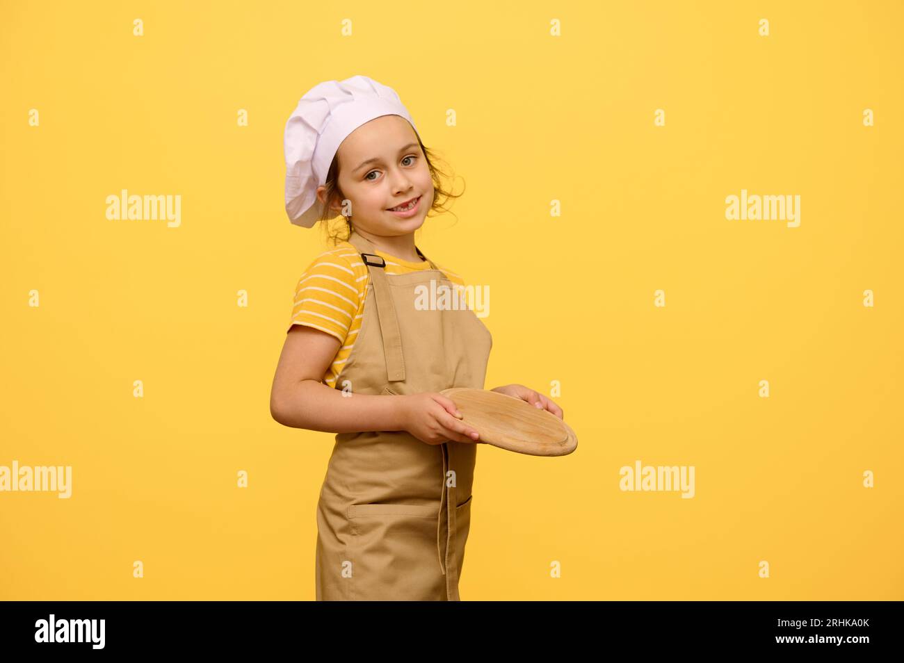 Caucasian cute little chef confectioner, cook, baker, pizzaiolo ...
