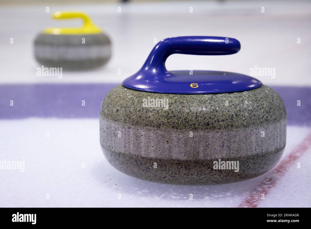 Detail of blue curling stone on ice Stock Photo - Alamy