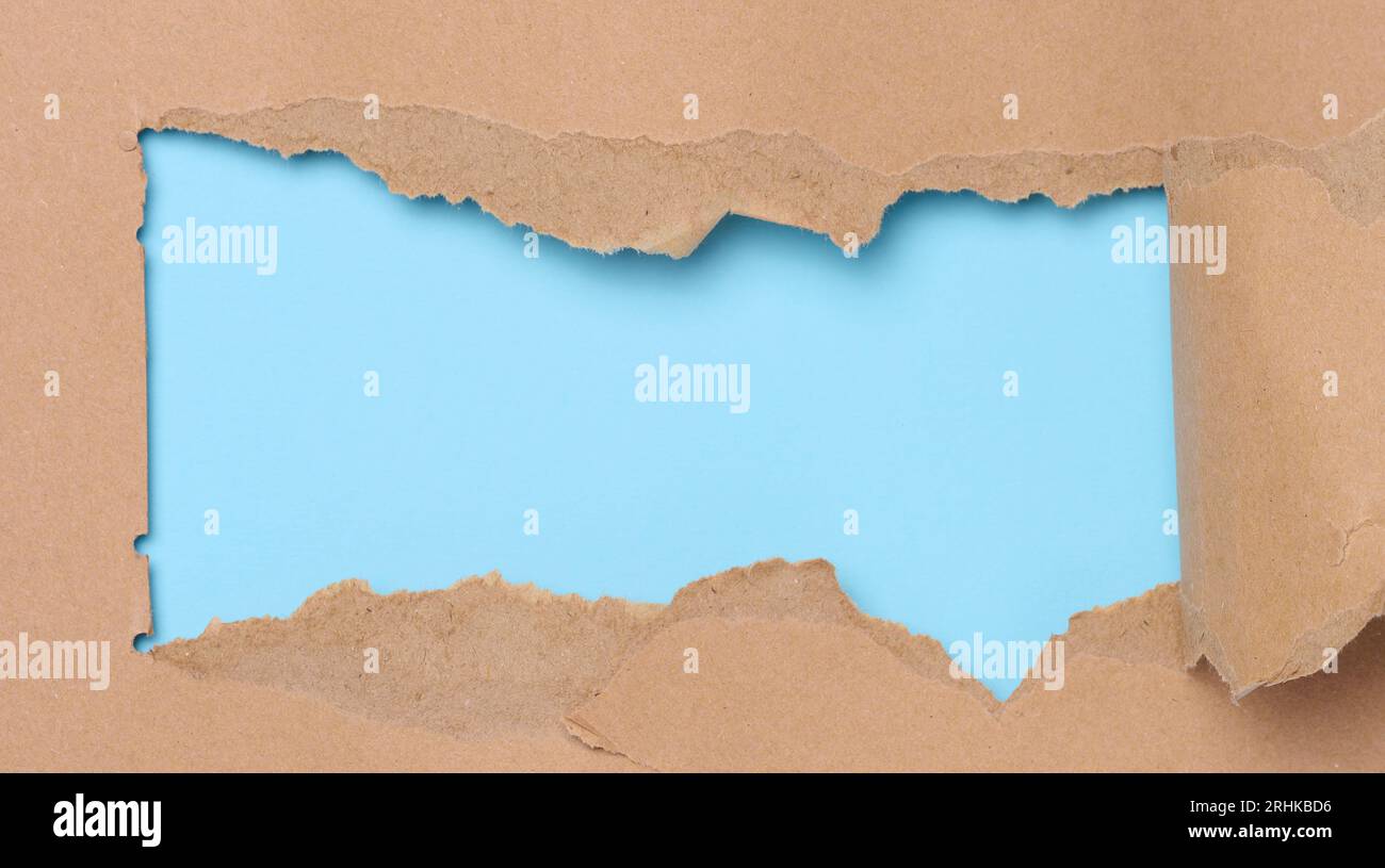Torn edges of brown paper on a blue background, space for writing Stock ...