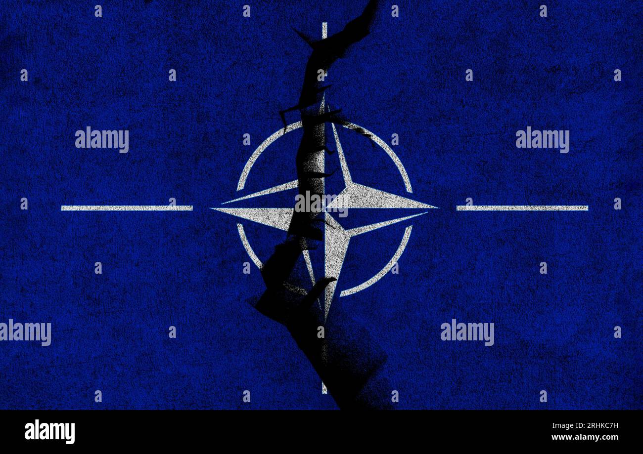 NATO flag on cracked wall background. NATO crisis, political division ...