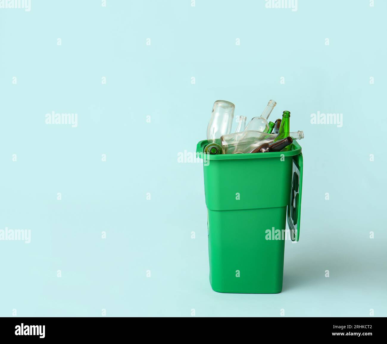 Container for garbage with glass bottles on light blue background ...