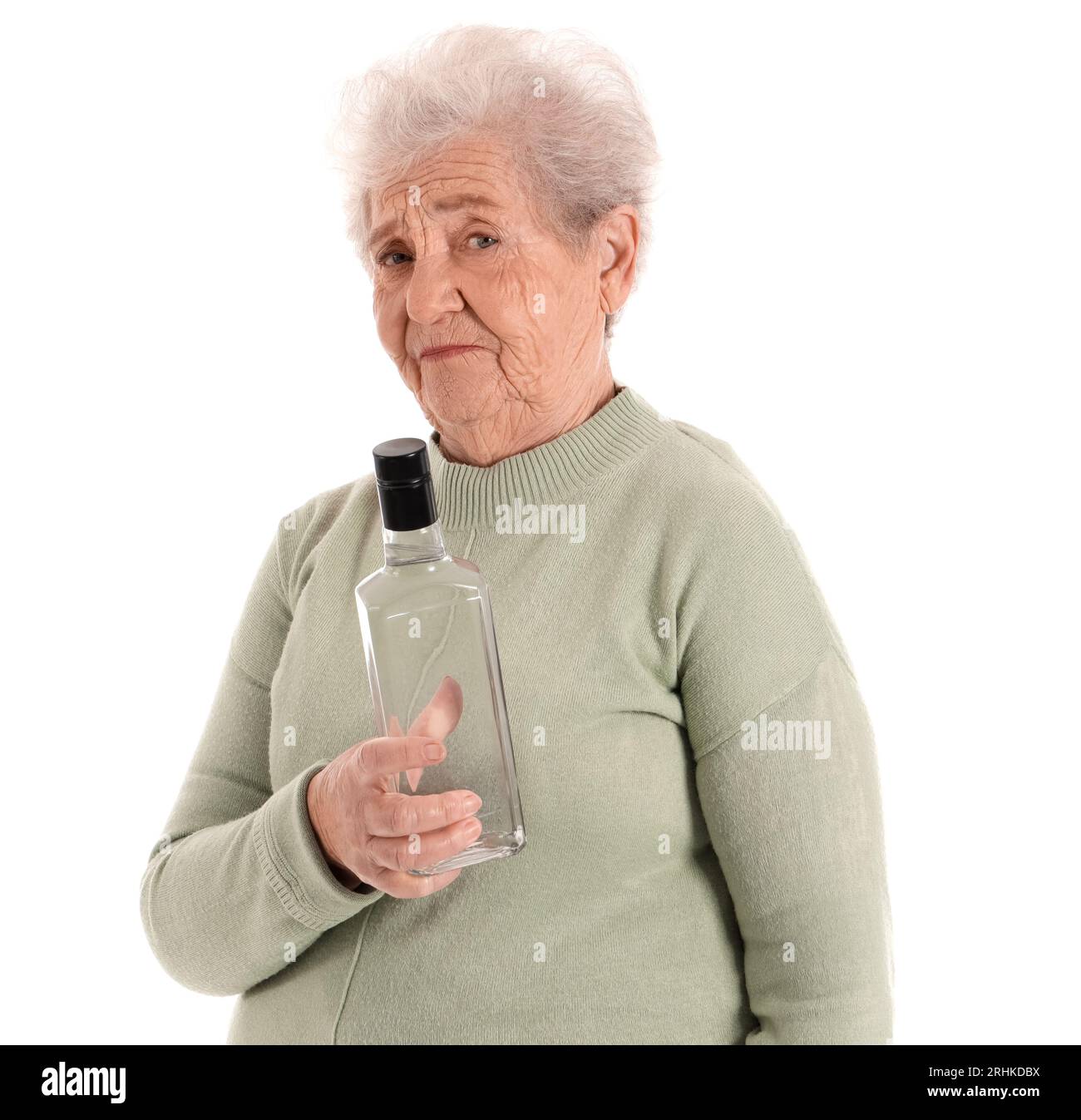 Senior woman with bottle of vodka on white background Stock Photo - Alamy