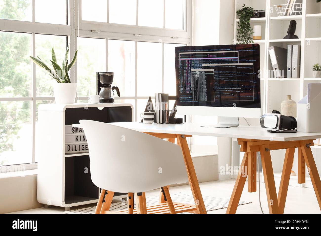 Computer monitor with programming code at workplace in office Stock ...