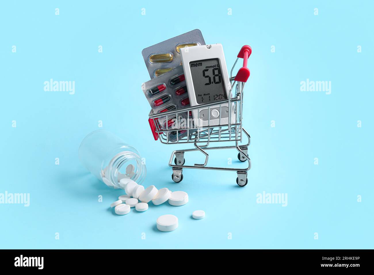 Shopping cart with glucometer and pills on blue background. Diabetes ...
