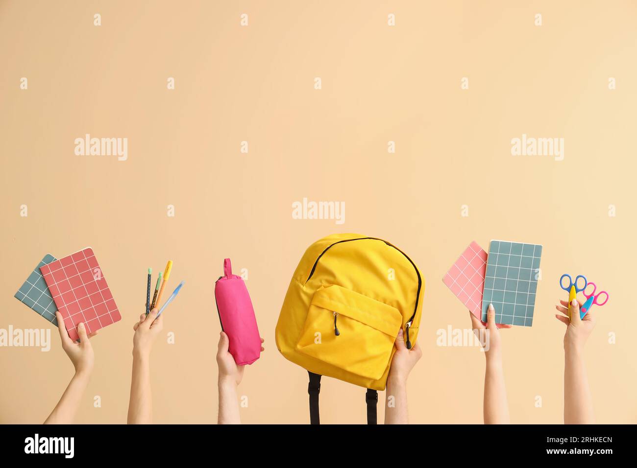 Hands holding school supplies on beige background Stock Photo - Alamy