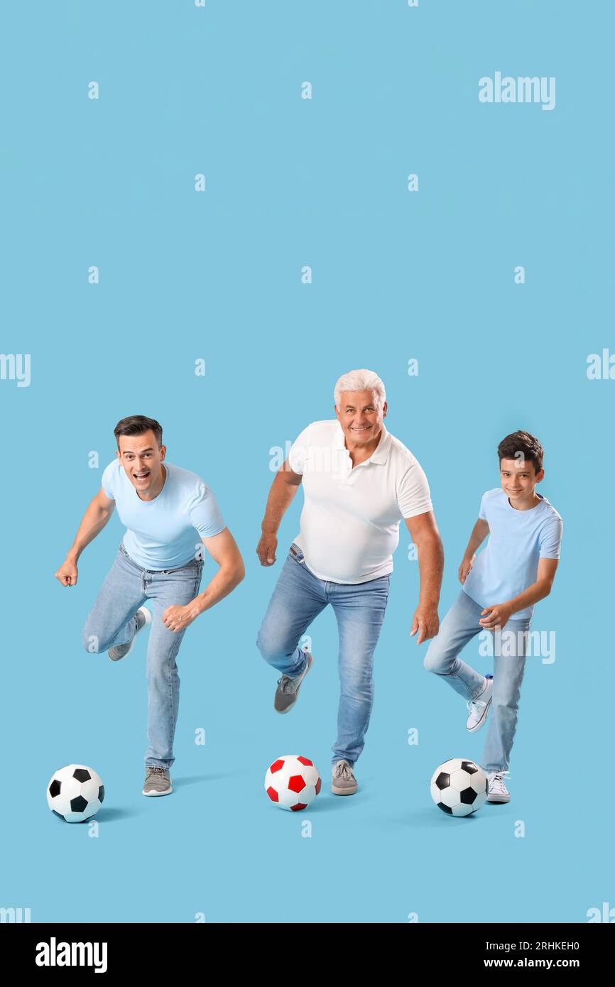 Little boy with his dad and grandfather playing football on blue ...