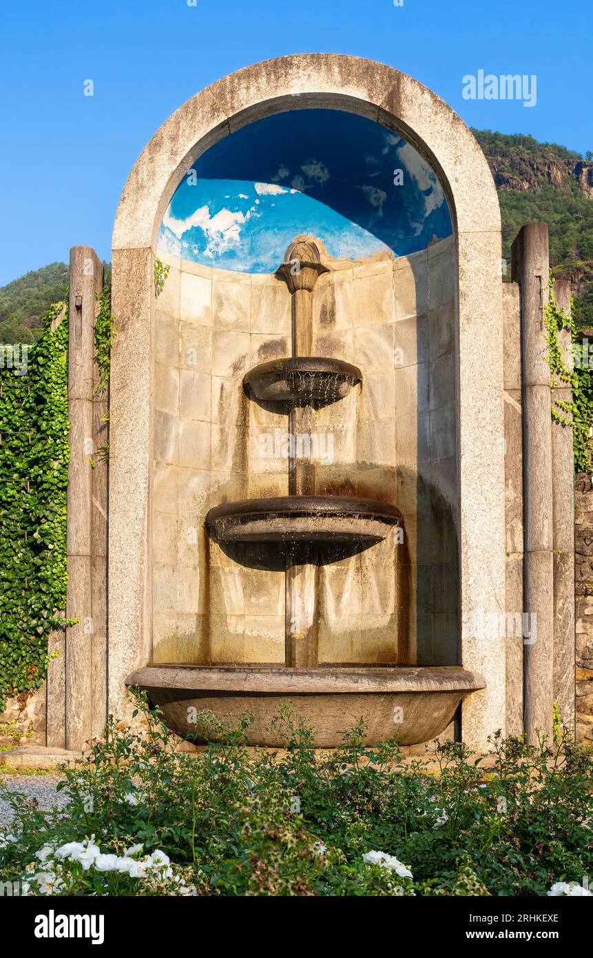 An idyllic stone fountain in the medieval town of Chiavenna, Italy ...