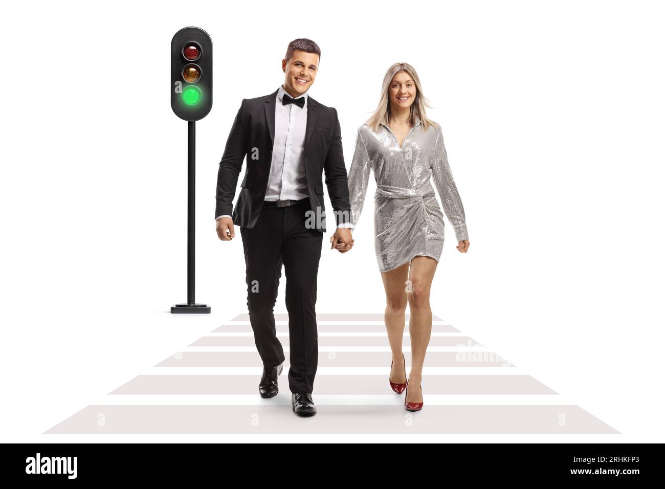 Full length portrait of a young couple in elegant clothes crossing a ...