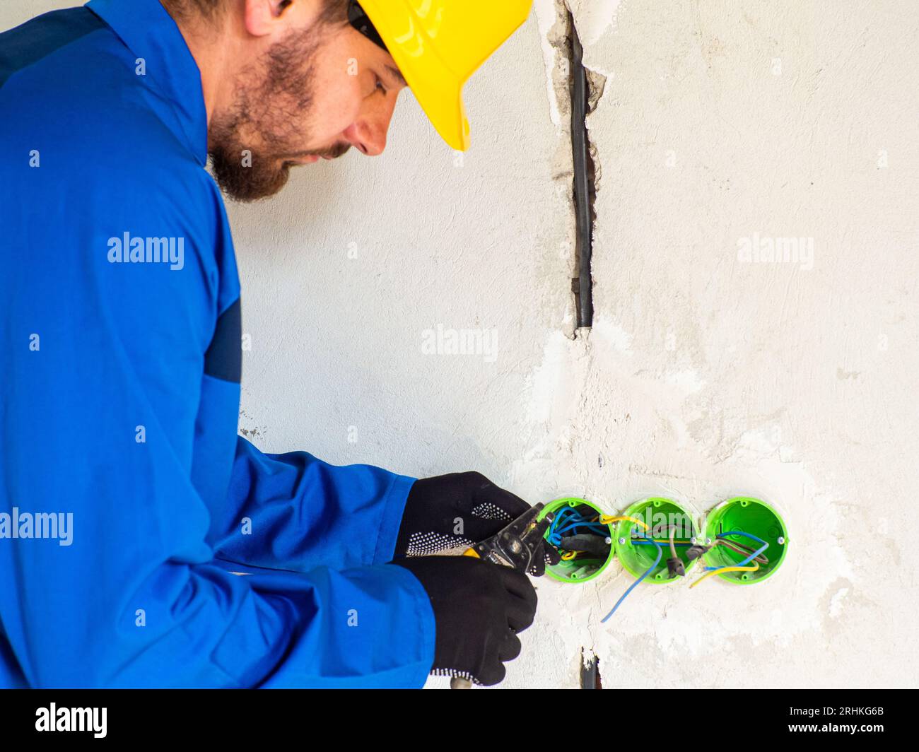 Professional electrician working on home electrical system Stock Photo ...