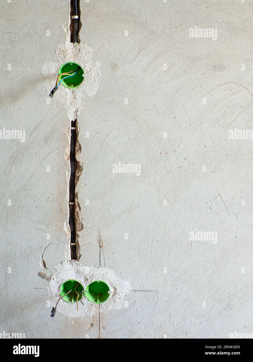 Plastic backbox for sockets or switches inserted into the drilled holes ...