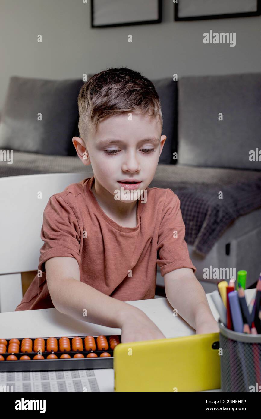 Little boy counting with the help of mental arithmetic. Mathematics in ...