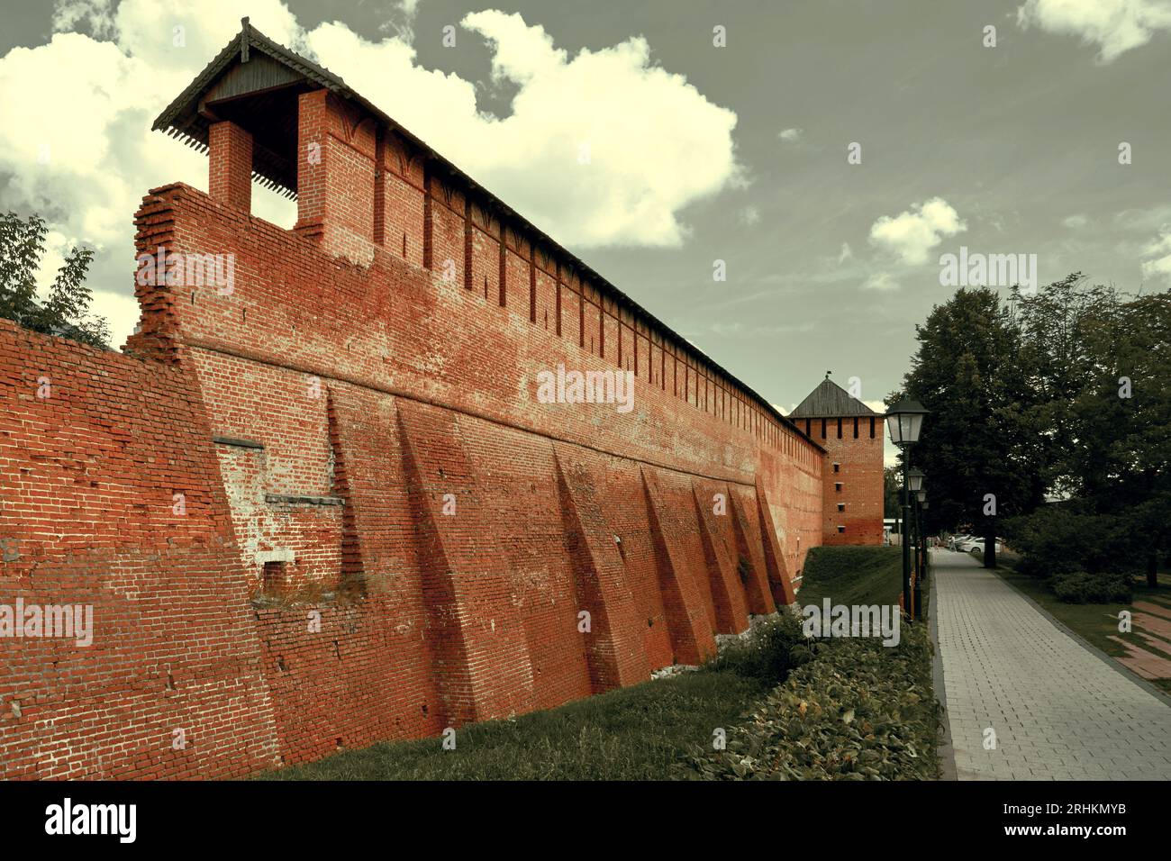 Ancient red brick fortress wall in the city park. Toned picture Stock ...