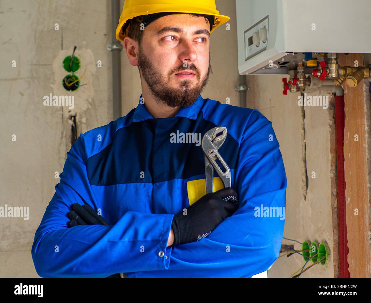 Portrait of worker or engineer in blue work clothes and yellow safety ...